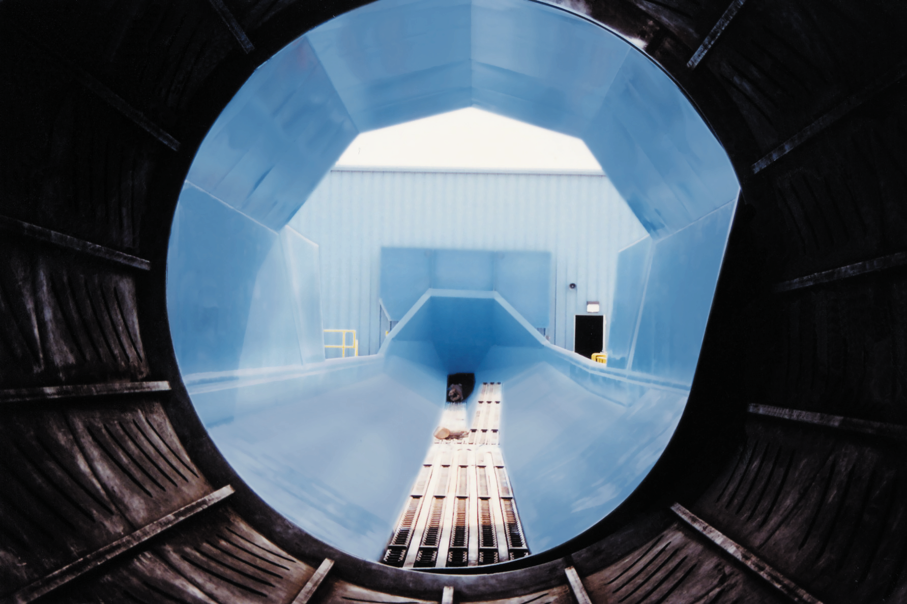 Debarker discharge and chipper infeed systems