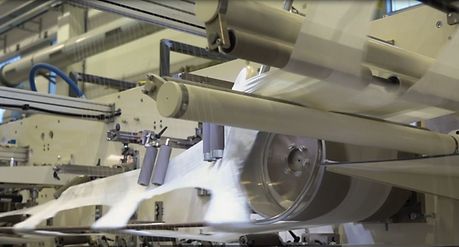 Nonwoven converting machines for adult care hygiene